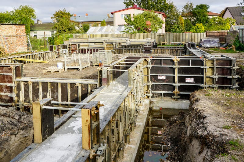 Concrete Foundations for the Columns of a Factory Building are Poured ...