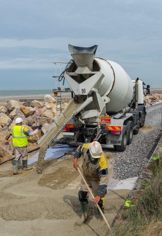 Construction of a Concrete Screed with Workers Leveling the Road or the ...