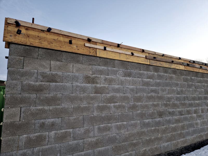Construction of a Concrete Wall from Concrete Blocks Filled Inside with ...