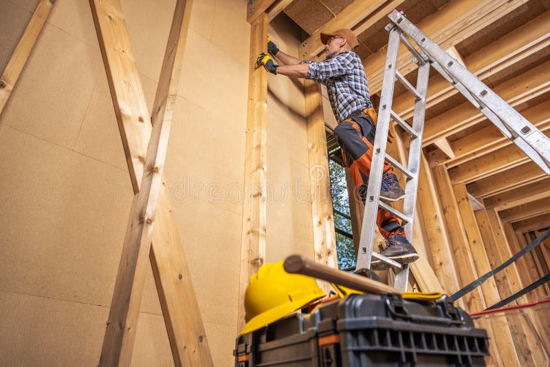 Construction Contractor on a Ladder Inside Newly Developed House Stock ...