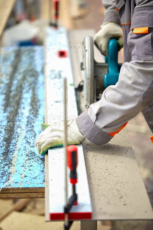 A Construction Contractor Worker Using a Worm-driven Hand-held Circular ...