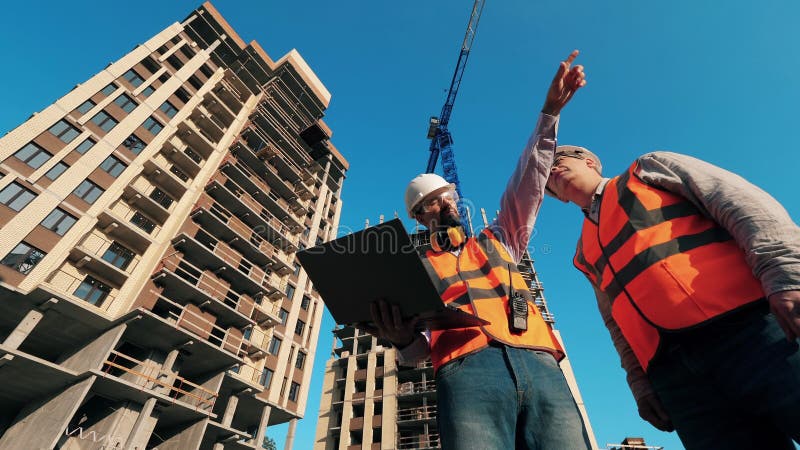 Construction Contractor Working on a Construction Site. Men Stand on a ...