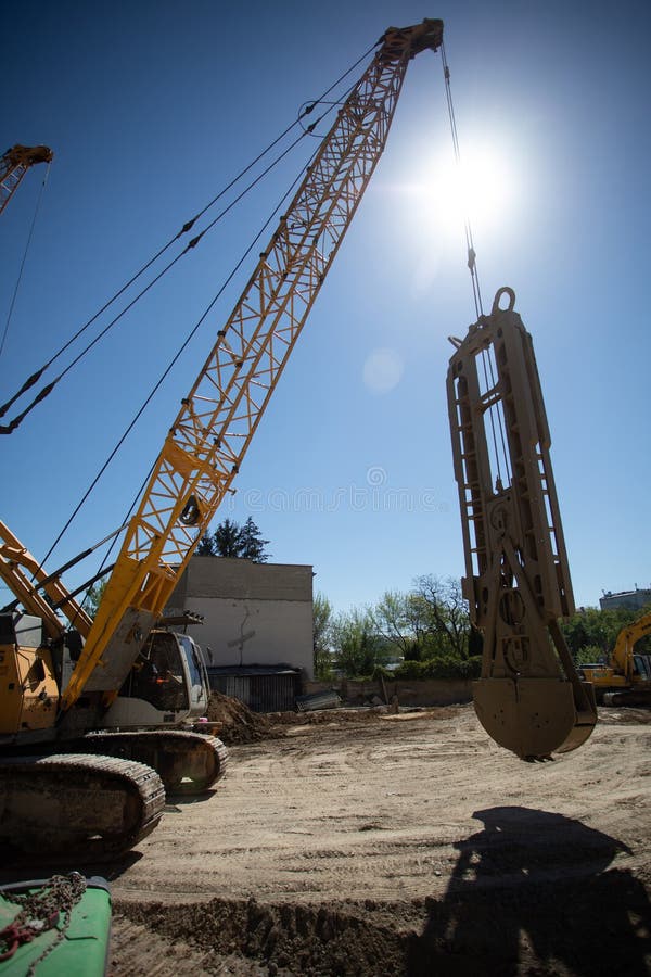A Construction Crane is Actively Working Under a Clear and Blue Sky on ...