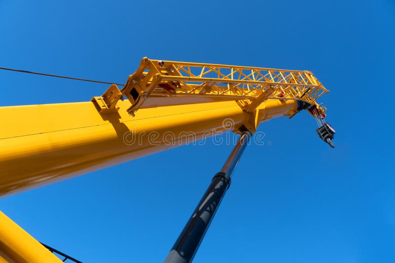 Construction Crane Arm with Hook Against Blue Sky Background. Mobile ...