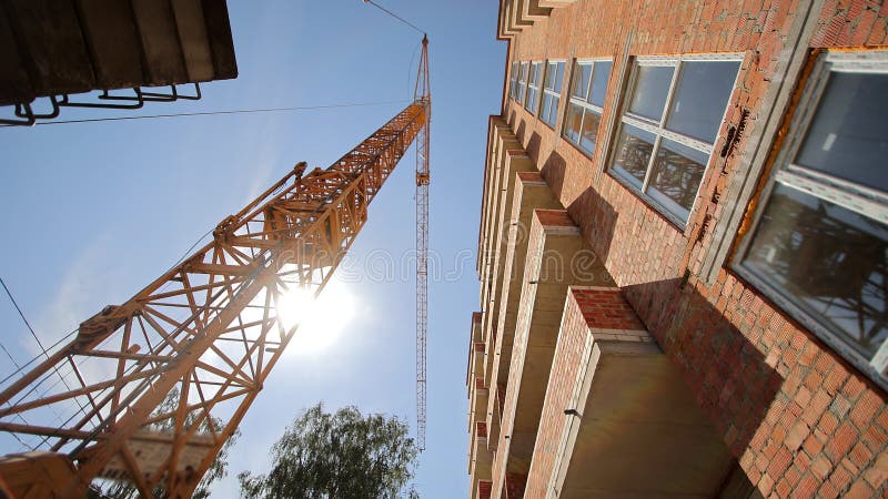 Construction Crane Bottom View. a Built Brick House and a Non-working ...