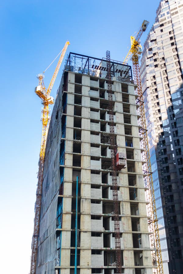 Construction Crane is Building a High-rise Building Stock Photo - Image ...