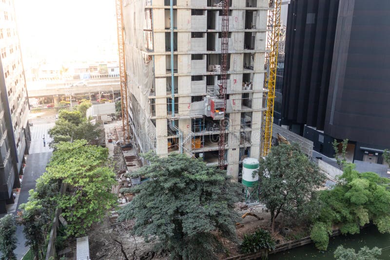 Construction Crane is Building a High-rise Building. Stock Image ...