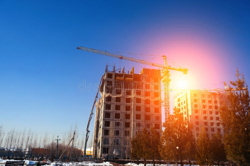 Construction Crane is Building a House on Background of a Blue Sky ...