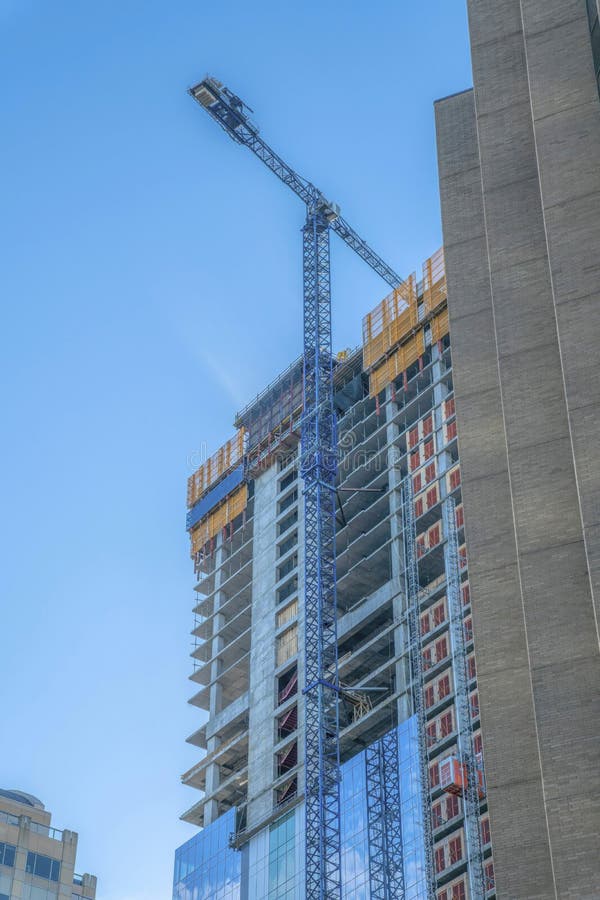 Construction Crane in Front of an Unfinished Building in Downtown ...