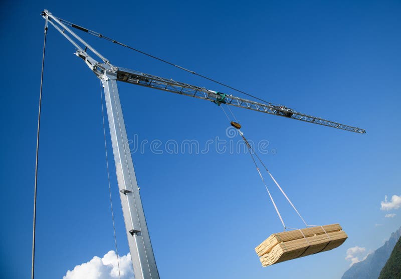 Construction Crane with Hanging Load of Wood Plank Stock Photo - Image ...