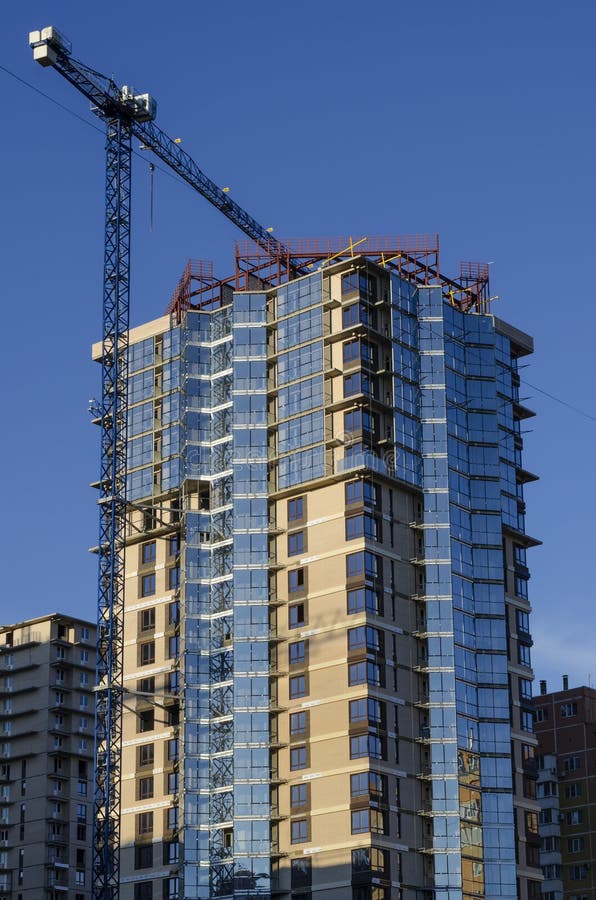 Construction Crane on a Background of High-rise Building Stock Photo ...