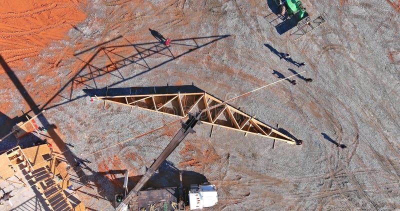 Construction a Crane Holds Timber Frame House of Residential Building ...