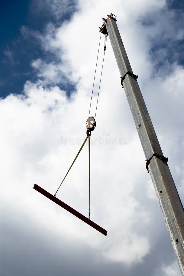 Construction Crane with a Hook and a Metal Profile Hanging on Ropes ...