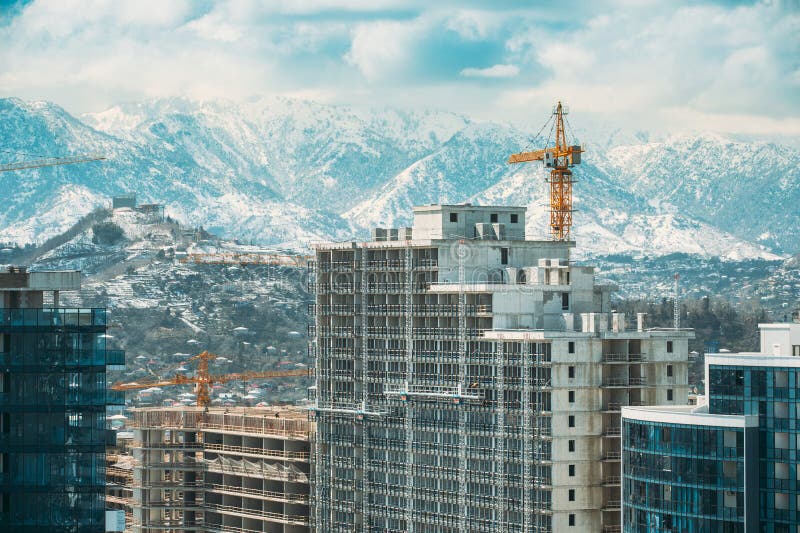 Construction Crane is Involved in Development of a New Multi-storey Residential Building. New ...