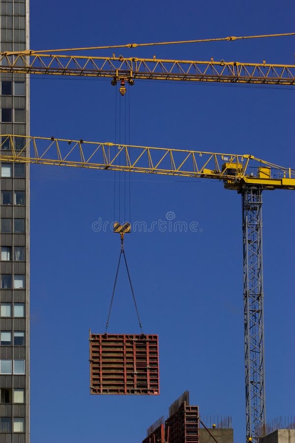 Construction crane lifting stock image. Image of building - 1937923