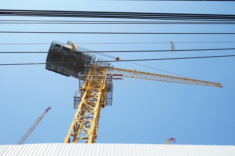 Construction Crane and Power Lines with Blue Sky Background. Low Angle ...