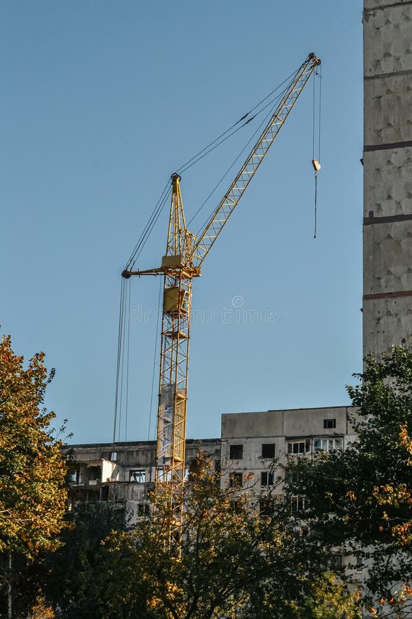 A Construction Crane Stands Next To the Broken House Stock Photo ...