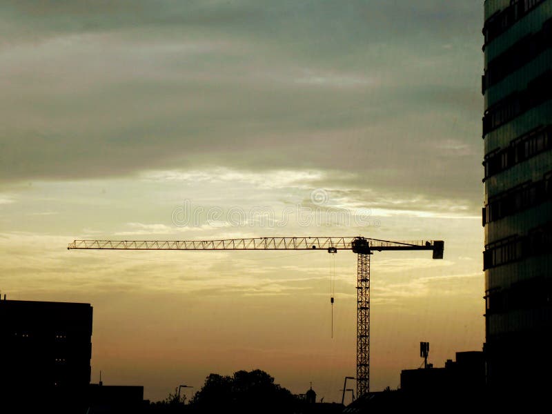 Construction Crane on Sunset Skyline in City. Skyscraper and ...