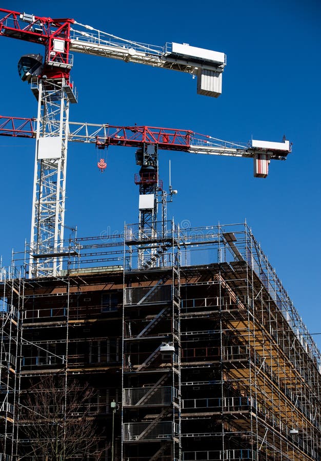 Construction crane working stock photo. Image of apartment - 145701228