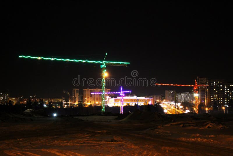 Construction Cranes at a Construction Site, Colored Light at Night ...