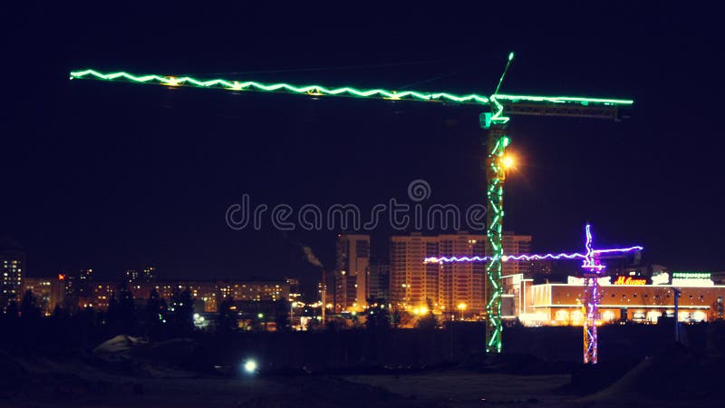 Construction Cranes at a Construction Site, Colored Light at Night ...