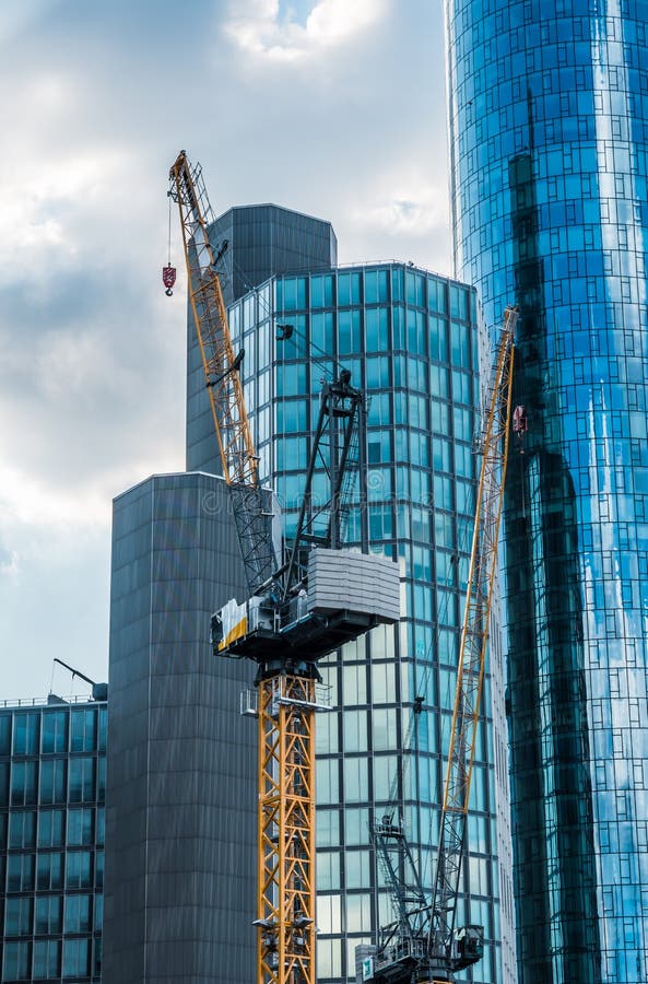 Construction Cranes in Front of Several Skyscrapers of Different ...