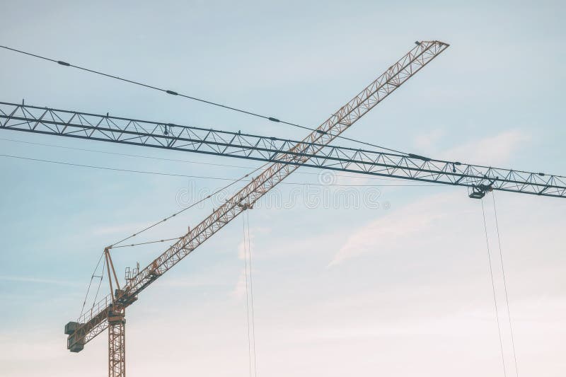 Construction Cranes Lifting Heavy Load on Construction Site Stock Photo ...