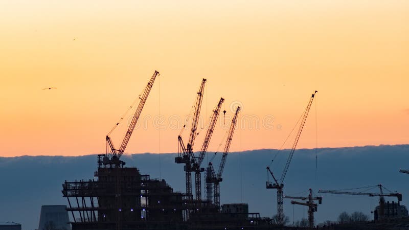 Construction Cranes at Sunset Stock Photo - Image of laborers, derrick ...