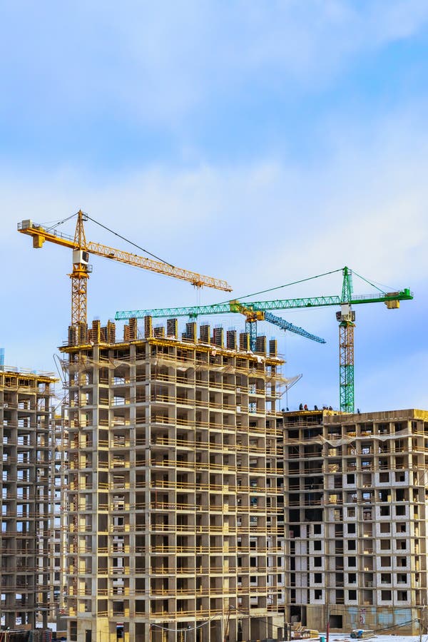 Construction Cranes Working on a Residential Building Site Under a Cloudy Sky in Moscow, Russia ...