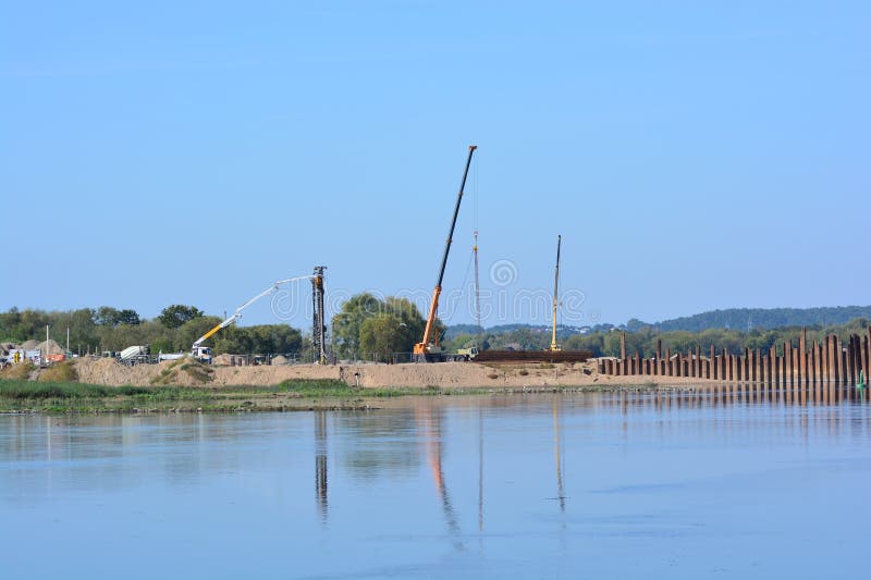 Construction Cranes Working in Construction Site Near the Water Stock ...