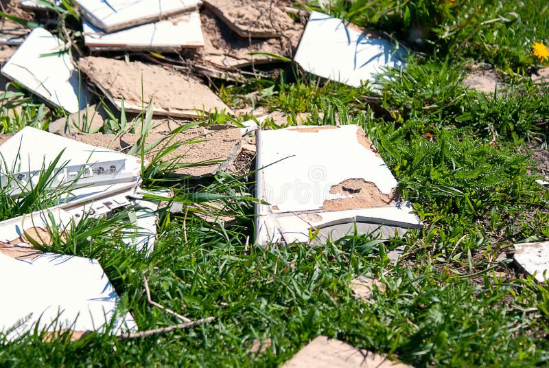 Construction Debris is Dumped in the Grass by the Side of the Road ...