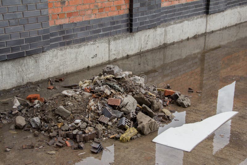 Construction Debris Lies in a Puddle. Remnants of Materials after Home ...