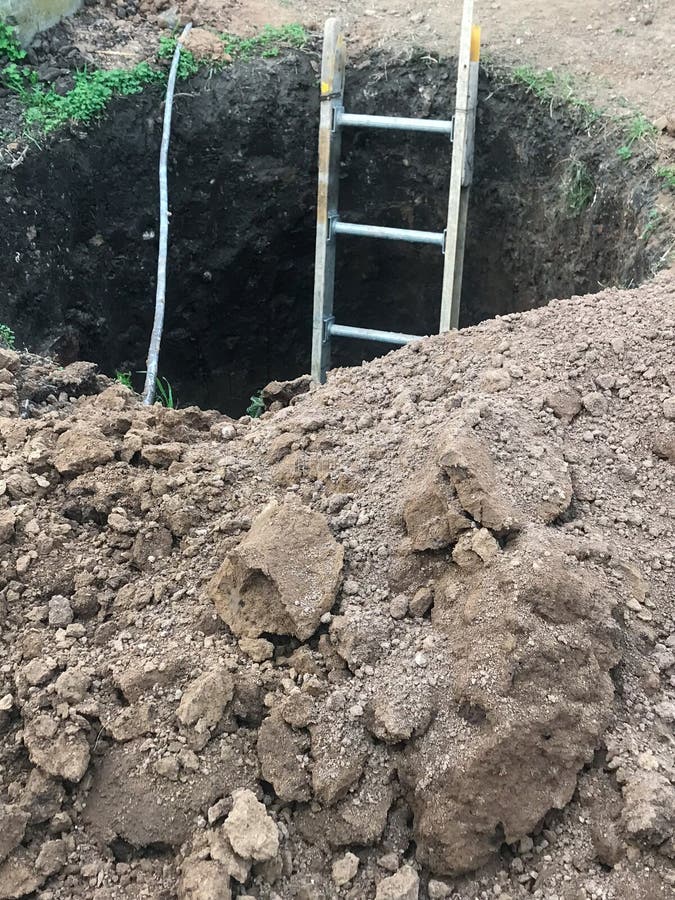 Construction of a Deep Well with a Ladder To Go Down. Building Site ...