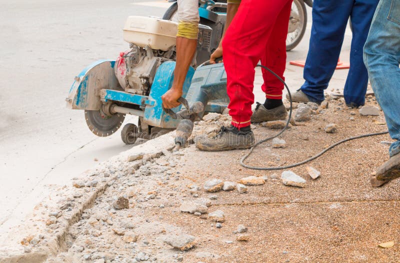 Construction Drilling Repair Worker on Road Surface with Heavy Duty ...