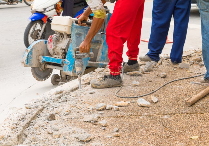 Construction Drilling Repair Worker on Road Surface with Heavy Duty ...
