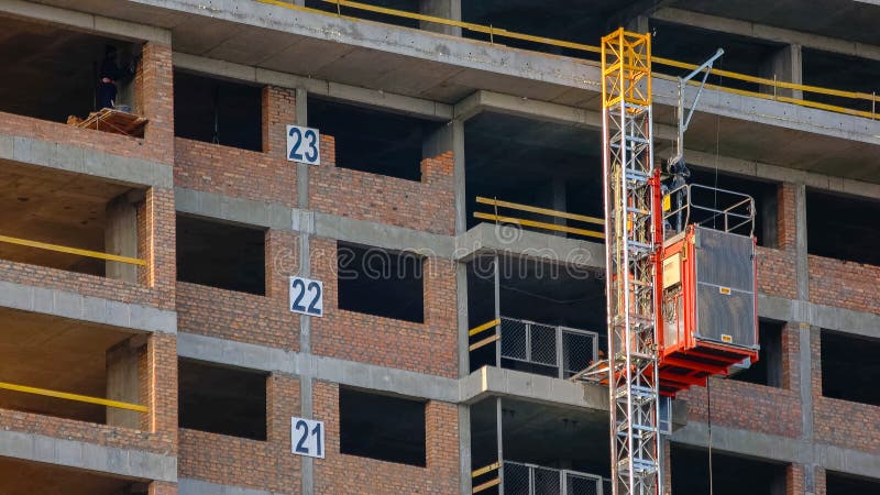 Construction Elevator with Workers in Lifting Up. Stock Photo - Image ...