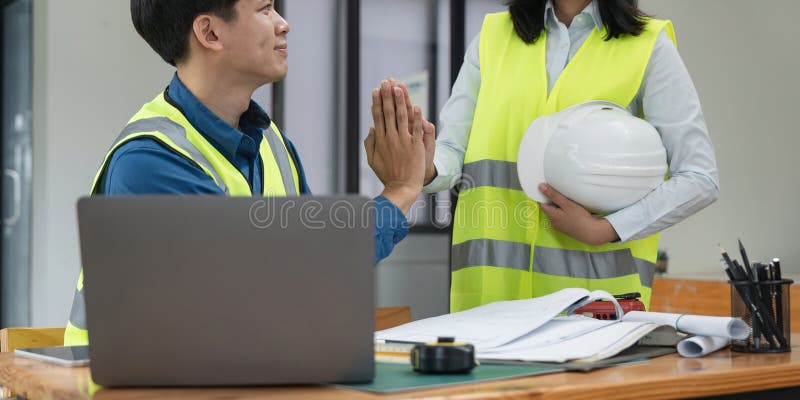 Construction Engineer with Blueprint Making High Five while Standing on ...