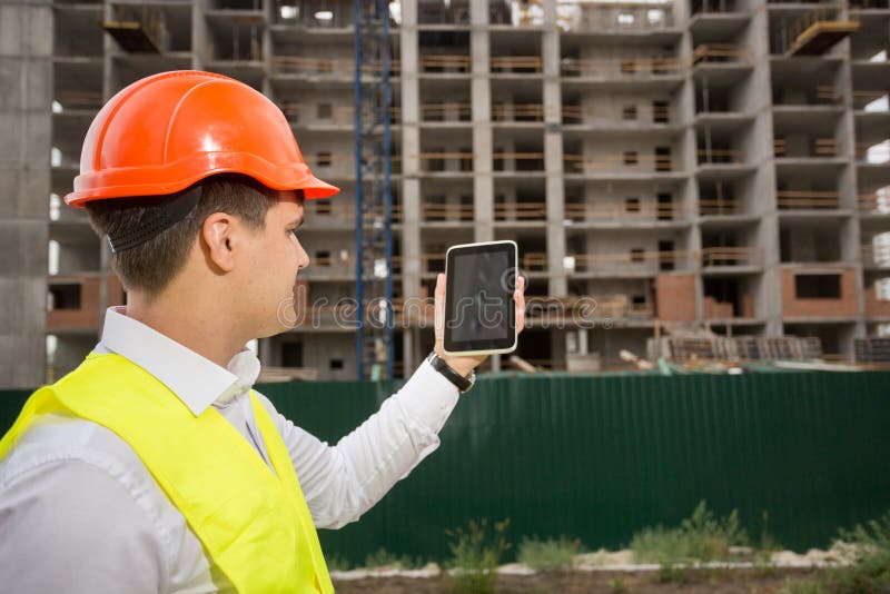Construction Engineer Talking by Phone and Looking on Building S Stock ...