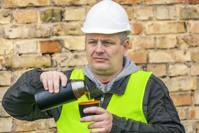 Construction Engineer Drinking Tea Near Stone Wall Stock Photo - Image ...