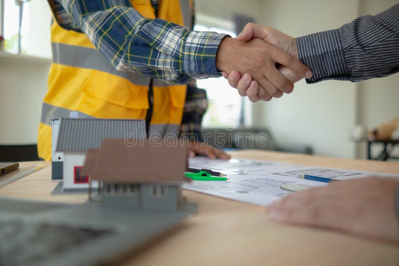 Construction Engineer Joins Hands with Architect To Congratulate ...