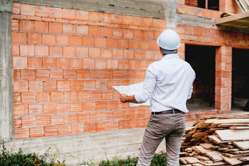 Construction Engineer with Plans, Working on Building Construction Site ...