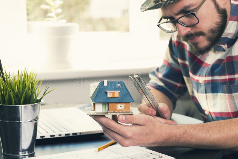 Construction Engineer Taking Measurements of New House Project Stock ...