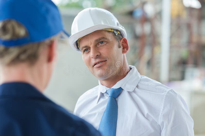 Construction Engineer Talking To Builder Stock Photo - Image of ...