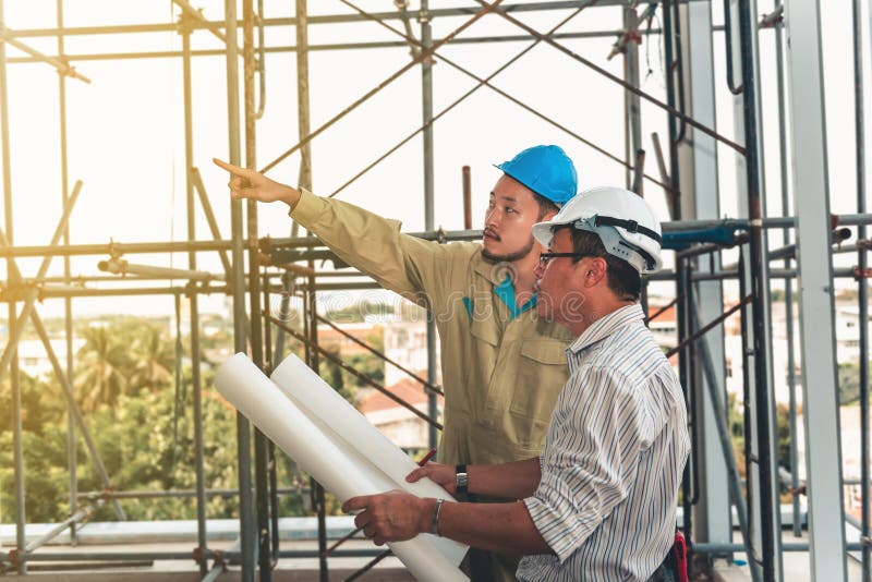 Construction Engineer Teamwork are Looking at Machine Installing Stock ...