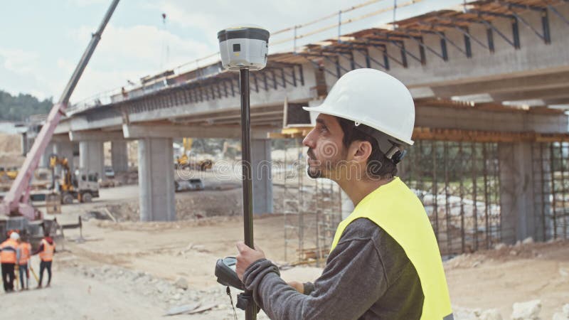 Construction Engineer Using a GPS Device for Measurements in a Large ...
