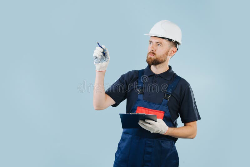 Construction Engineer in a White Helmet and Blue Uniform with a Paper ...