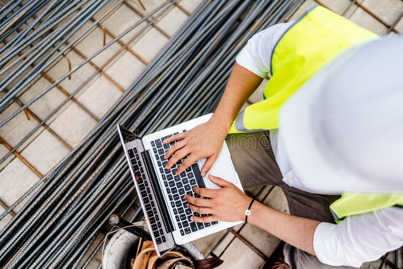 Construction Engineer Working on Laptop, Wearing Safety Equipement and ...