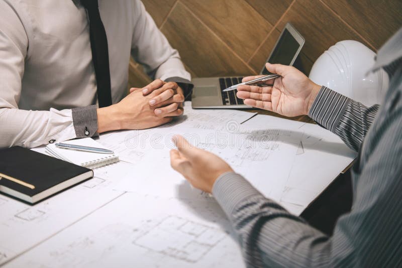 Construction Engineering or Architect Discuss a Blueprint while ...