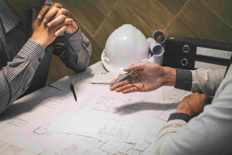 Construction Engineering or Architect Discuss a Blueprint while ...