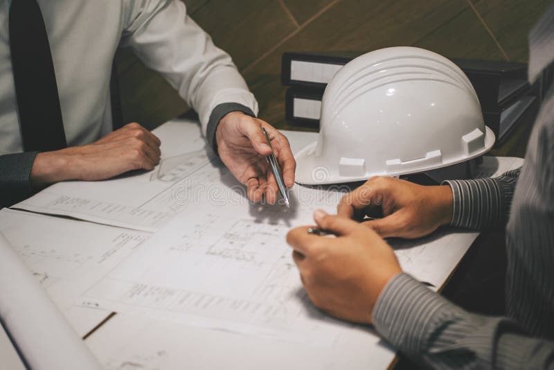 Construction Engineering or Architect Discuss a Blueprint while ...